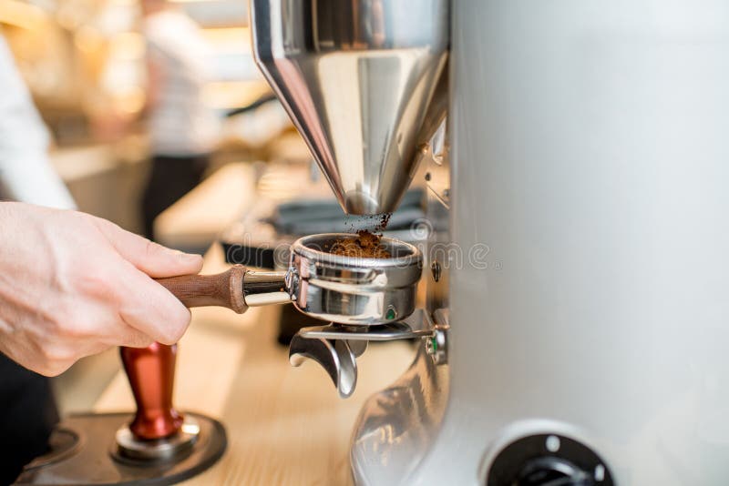 Grinding a Coffee into the Handle of the Coffee Machine Stock Photo ...