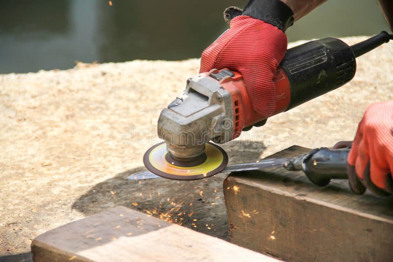 Grinding Machine Being Used To Remove Rust on Axes. Stock Photo - Image ...