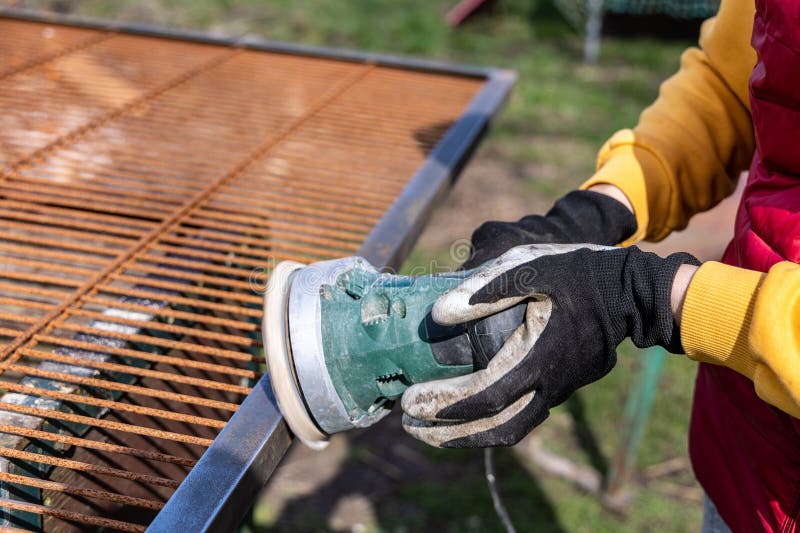 Grinding of a Metal Grid Using a Vibrating Sander Stock Image - Image ...