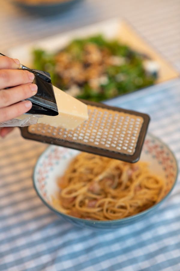 Grating Parmesan Cheese To Carbonara Stock Photo - Image of grinder ...