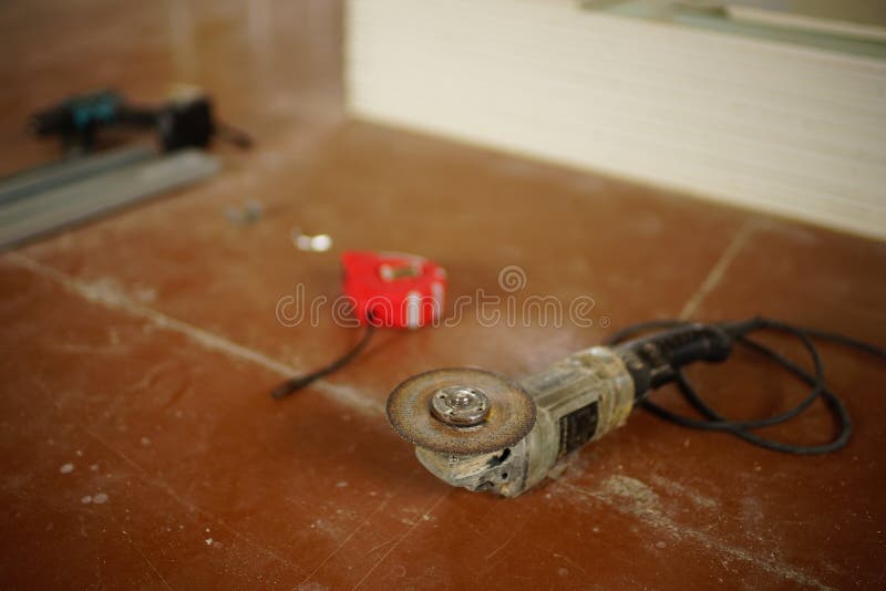Grinding Tool with Abrasive Cutting Disc and Other Tools on the Dirty ...