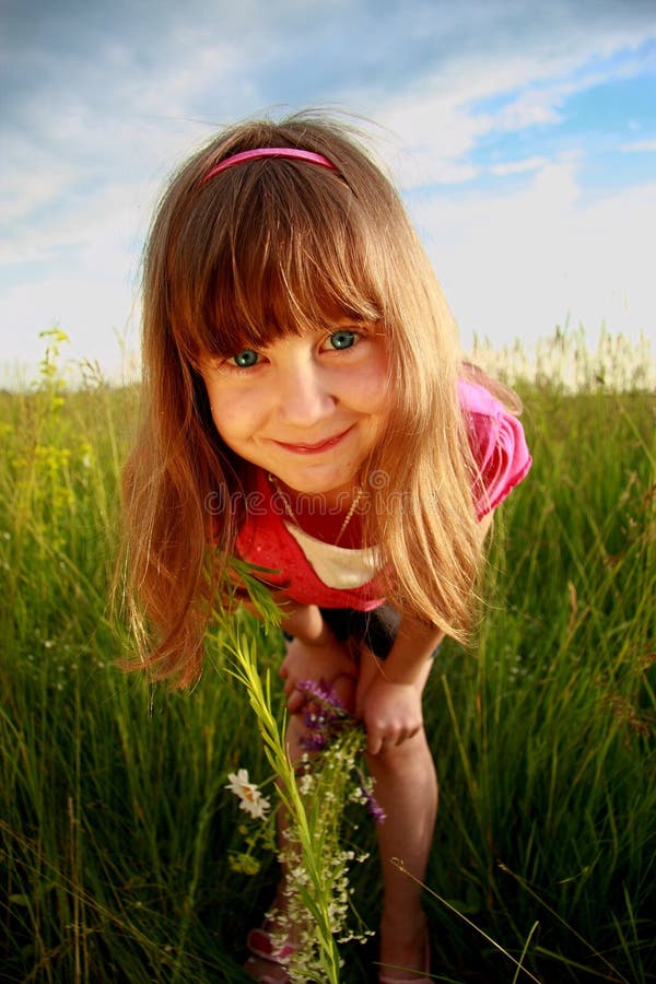 Grinning Girl in a Field stock image. Image of wide, eyes - 5458947