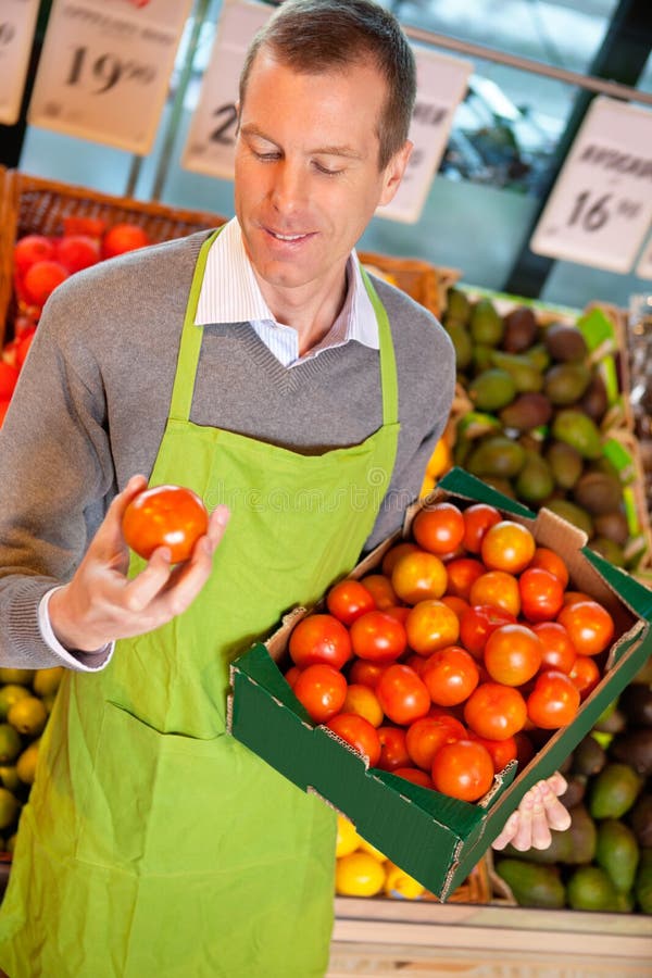 Grocery Store Clerk with Tomatoes Stock Image - Image of small, organic ...