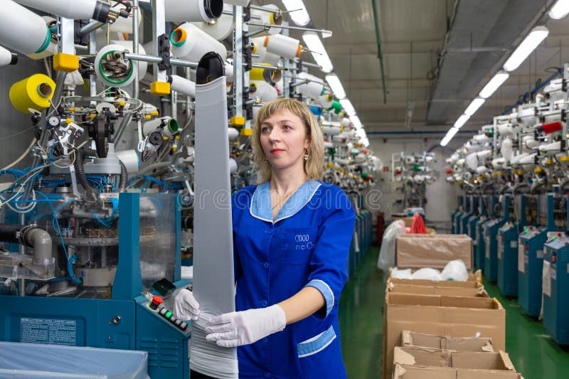 A Female Employee Performs Visual Quality Control of the Lace Ribbon ...