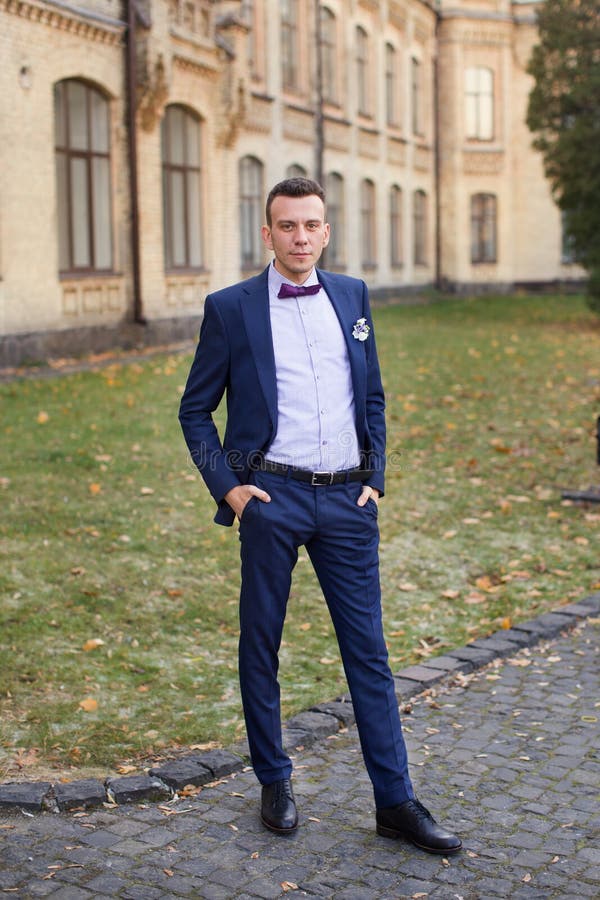 The Groom in a Blue Suit and Bow Tie Posing in the Photo Stock Image ...