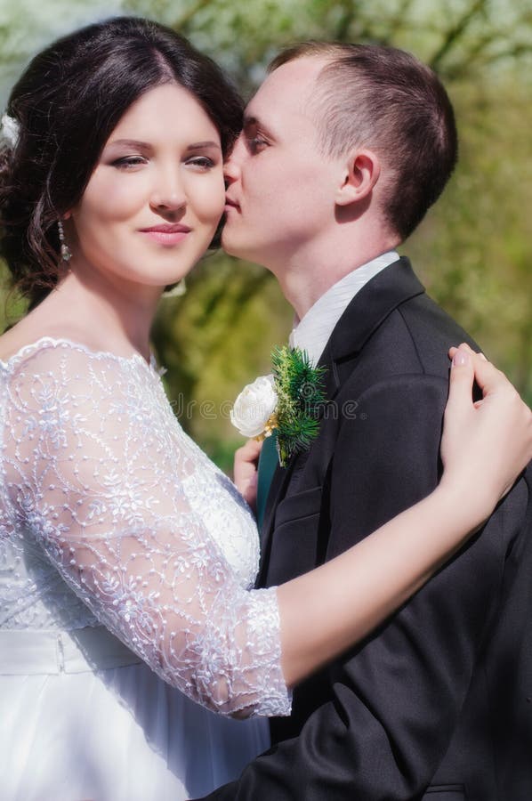 Groom and Bride in a White Dress in the Spring Garden Stock Photo ...