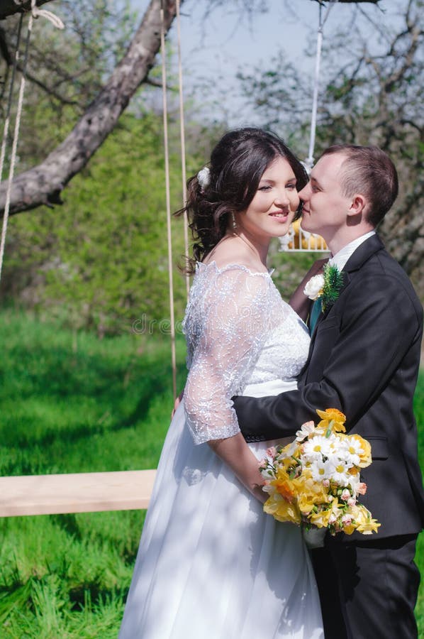 Groom and Bride in a White Dress in the Spring Garden Stock Photo ...