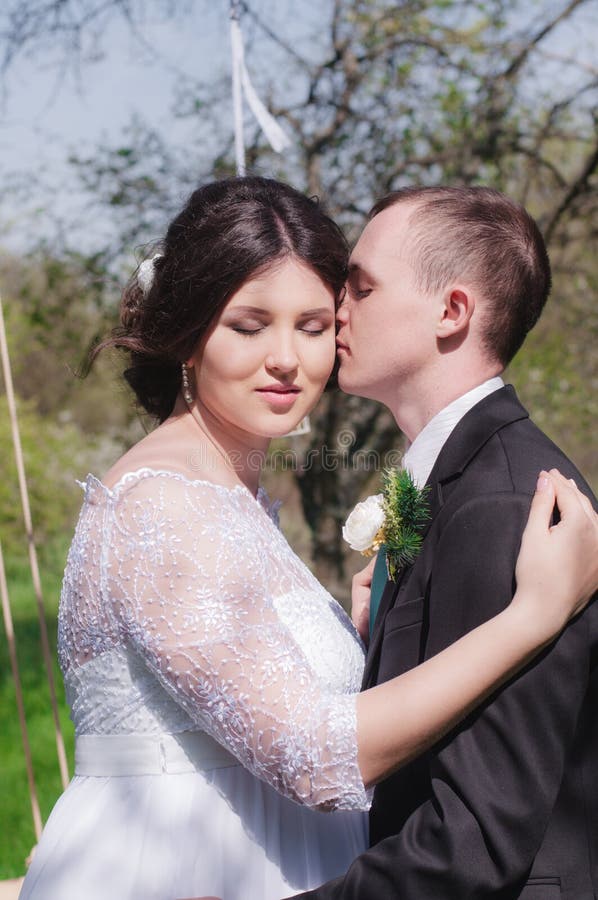 Young Bride and Groom in a Lush Garden in the Spring. Groom and the ...