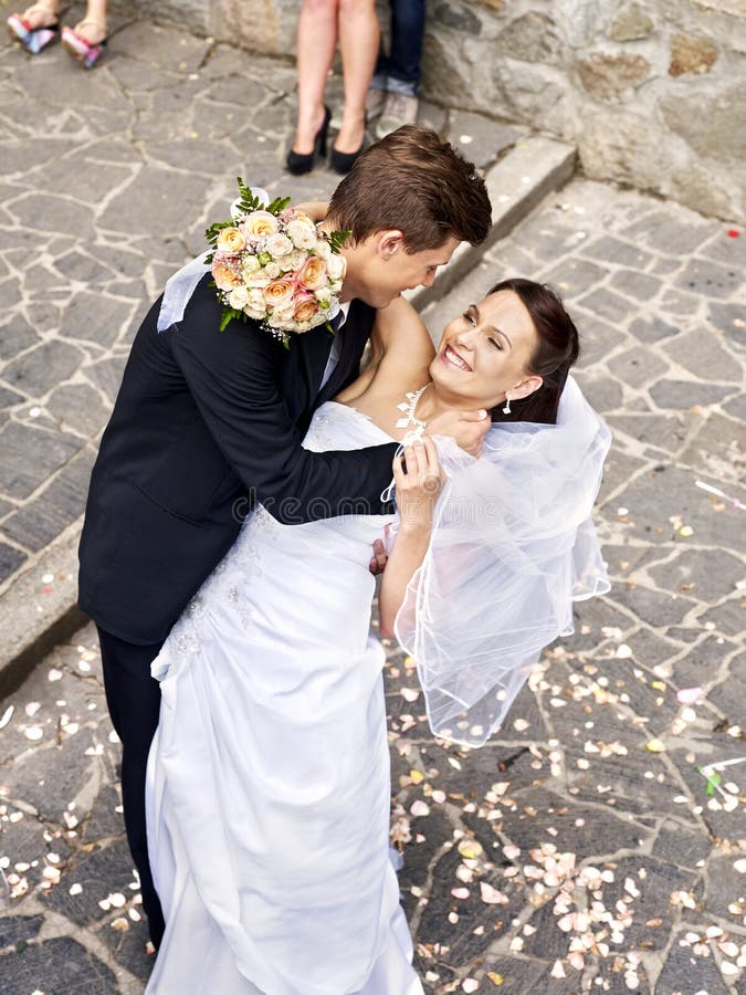 Groom Carries His Bride Over Shoulder. Stock Photo - Image of city ...