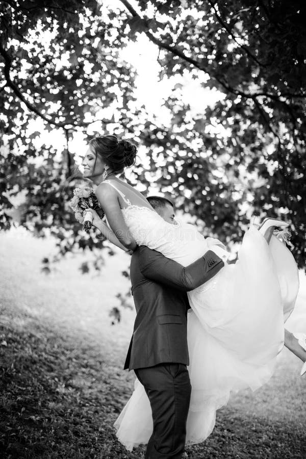 Groom Carries His Bride Over Shoulder Stock Image - Image of girl ...