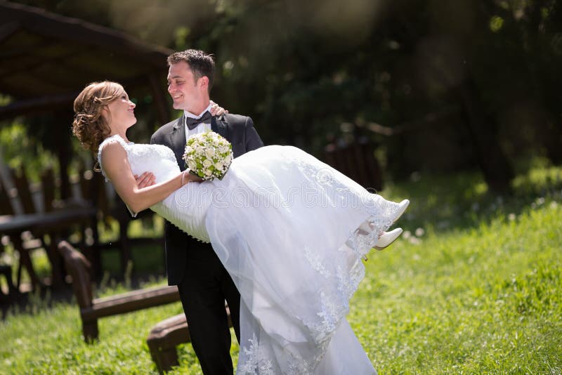 Groom Carrying Bride Outdoors Stock Image - Image of happiness, nature ...