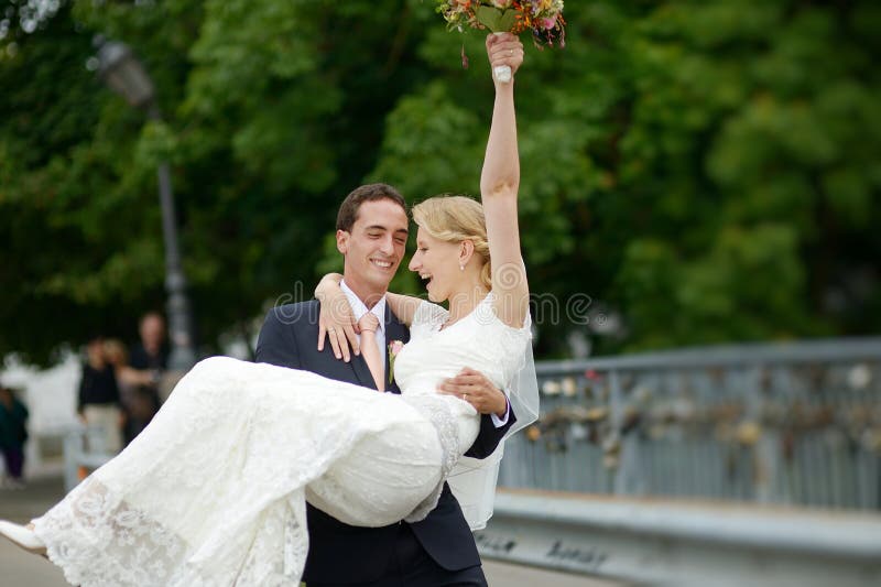 Groom carrying his bride stock image. Image of fashion - 32344647