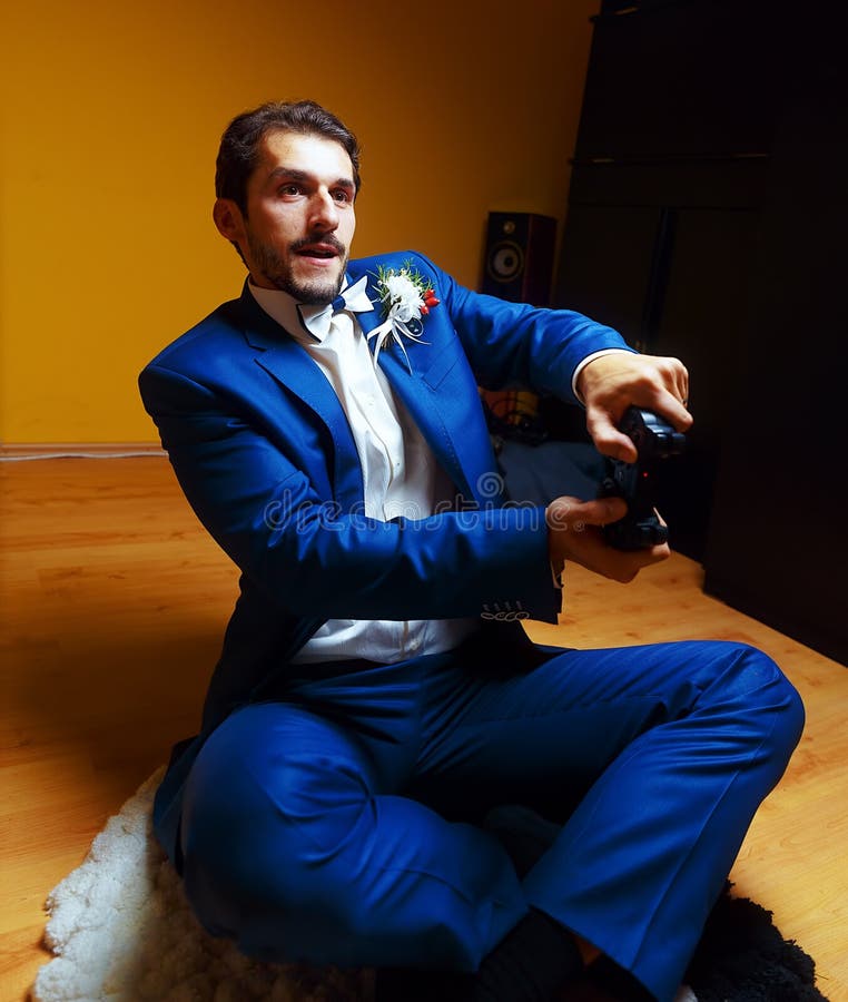 Groom Game Computer Game while Sitting on the Carpet. Stock Photo ...