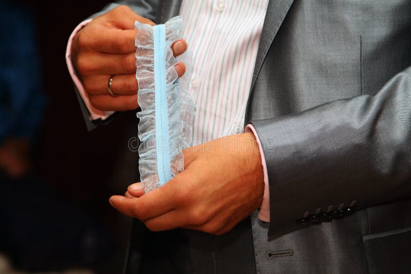 Groom Holding Bridal Garter Stock Photo - Image of husband, groom: 13362690