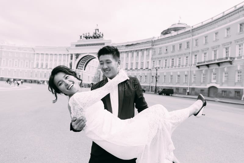 Groom holding bride stock photo. Image of celebration - 82530168