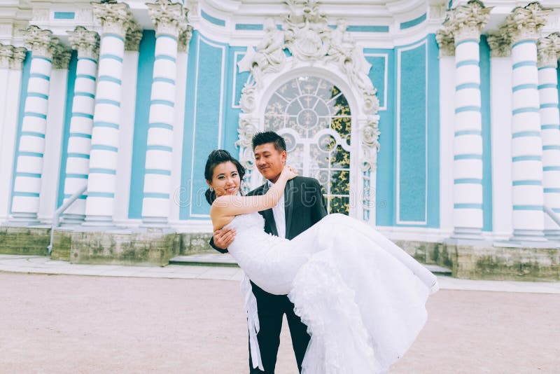 Groom holding bride stock photo. Image of cheerful, jump - 82895844