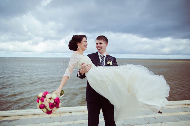 Groom holding bride stock image. Image of holidays, married - 49224957