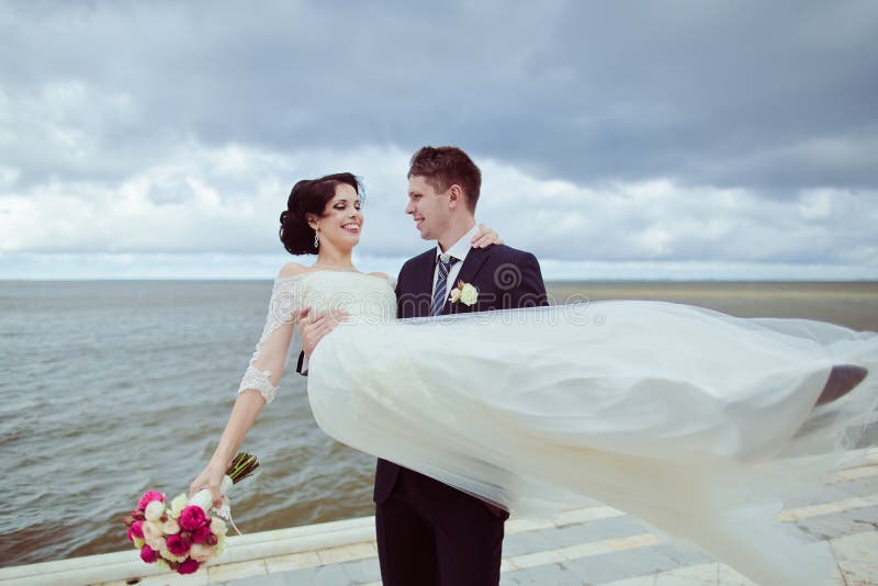 Groom holding a bride stock photo. Image of husband, fashion - 83533096