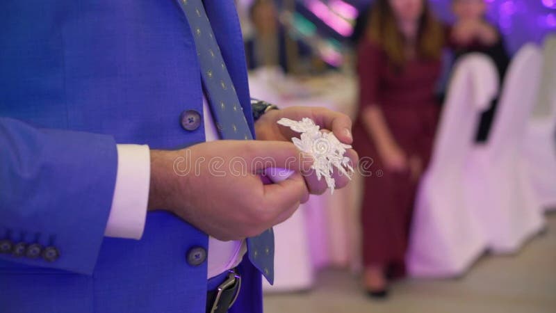 Groom Holding Garter at Wedding Reception. Traditional Throwing Stock ...