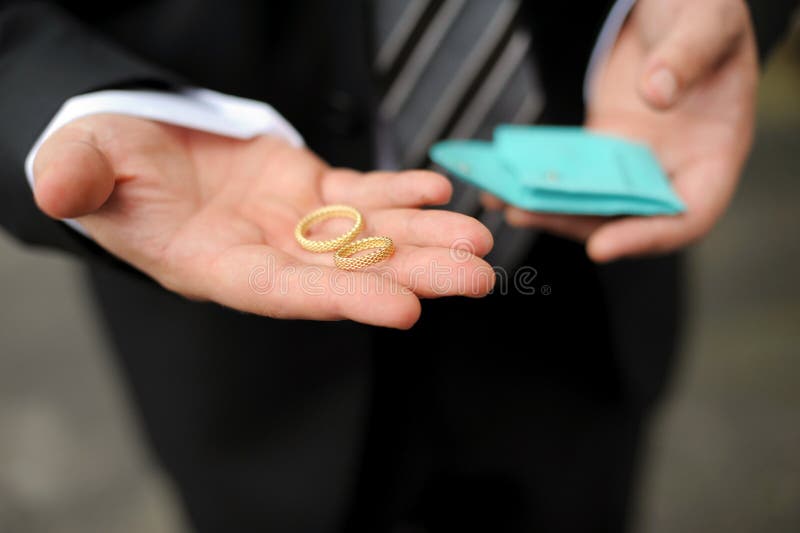 Groom Holding Two Gold Wedding Rings Stock Image - Image of color ...