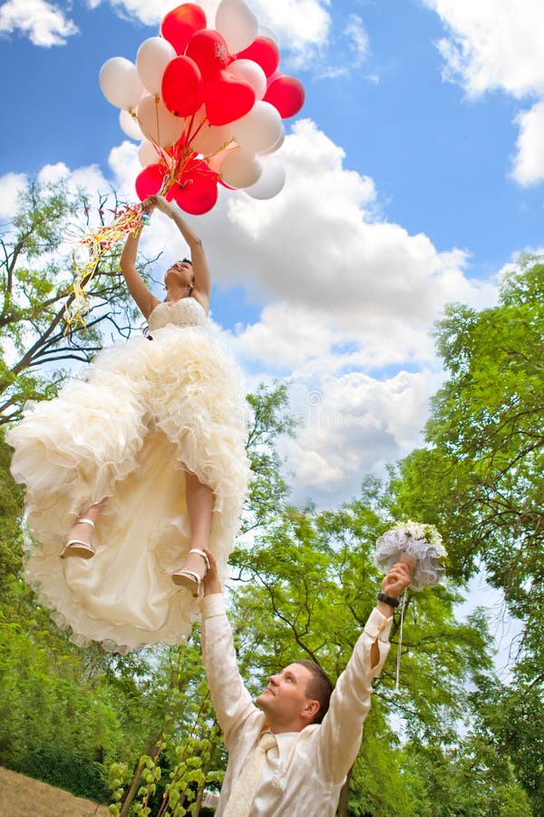 Groom Keeps a Bride Flying Away Stock Photo - Image of green, female ...
