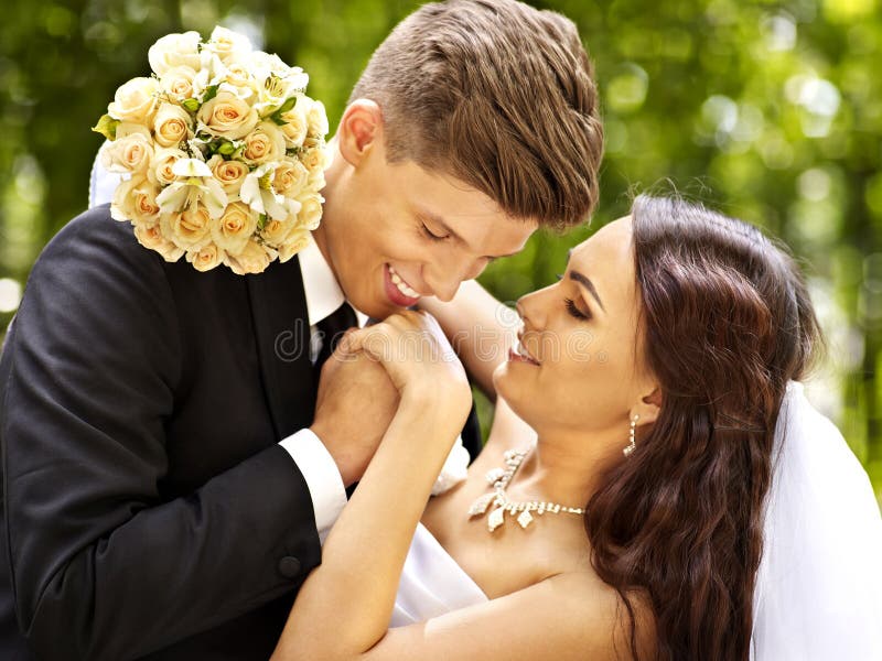 Groom Kissing Bride on Shoulder . Stock Photo - Image of flower ...