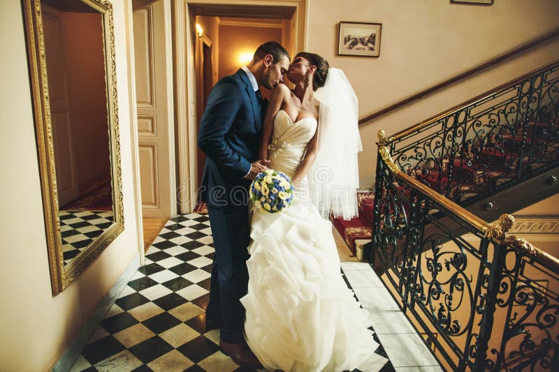 Groom is Kissing Bride Shoulder on the Background Corridor with Stock ...
