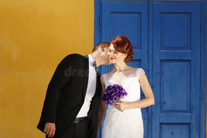 Groom kissing his bride stock photo. Image of concept - 65657186