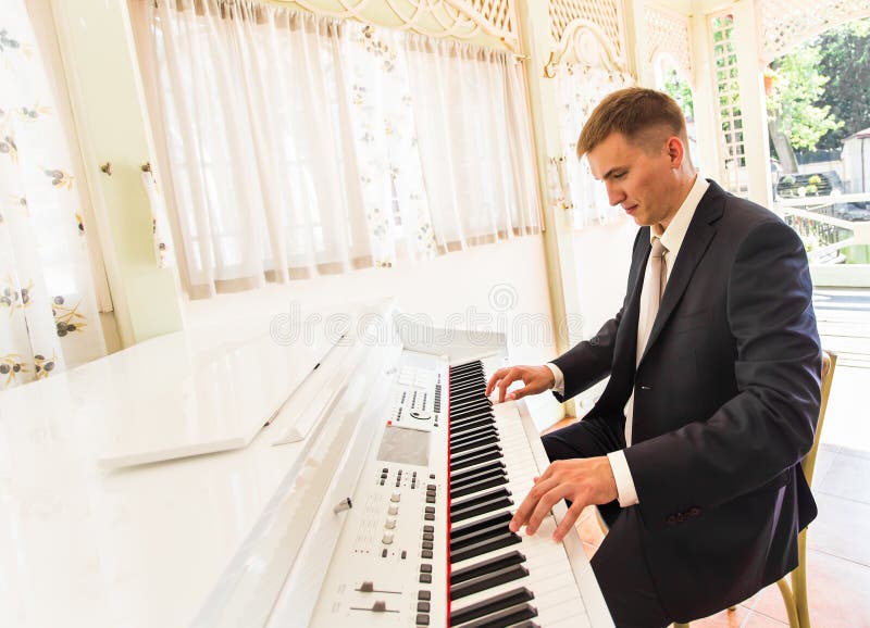 Groom Playing on a Piano in the Room Stock Photo - Image of grace ...