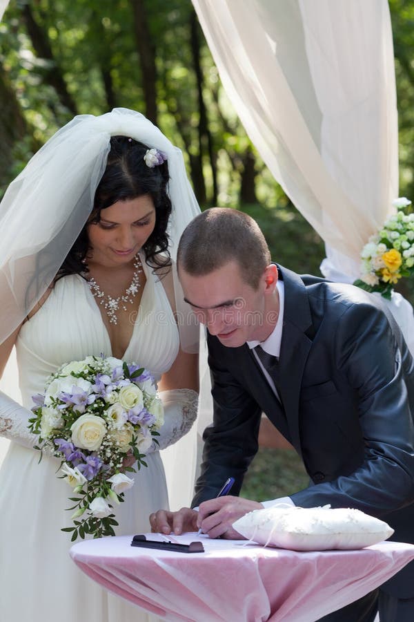 Groom puts the signature stock image. Image of couple - 26700845