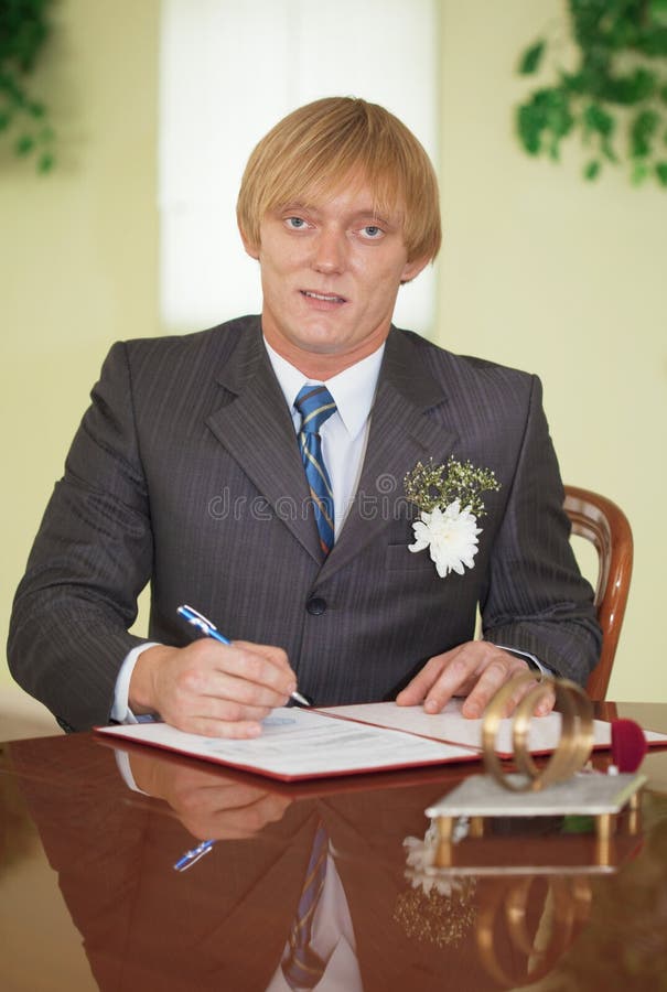 Groom Puts Signature on Registration Document Stock Photo - Image of ...