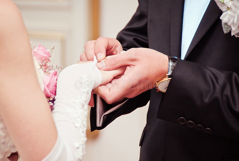 Groom Putting a Wedding Ring on Bride S Finger Stock Photo - Image of ...