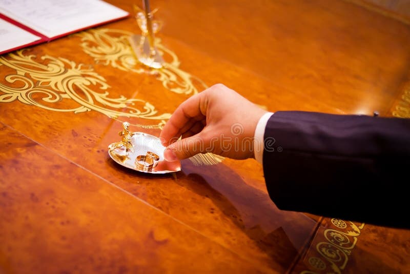 Groom s hand taking ring stock photo. Image of bowl, wedding - 24230584