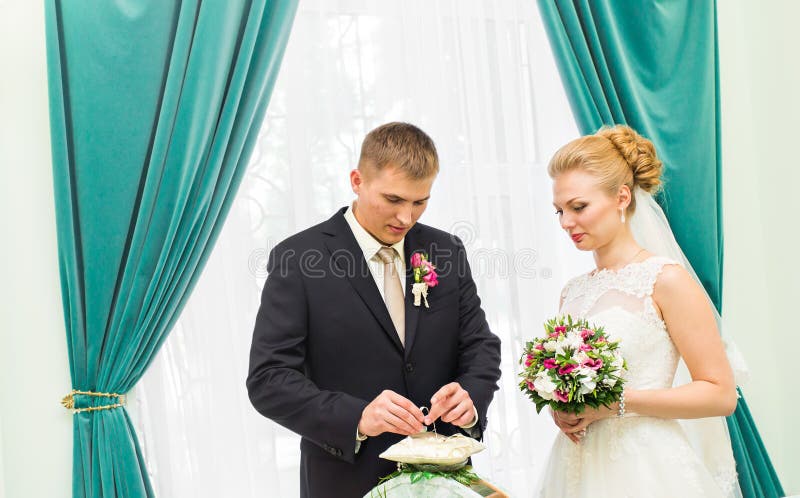 Groom Slipping Ring on Finger of Bride at Wedding Stock Photo - Image ...