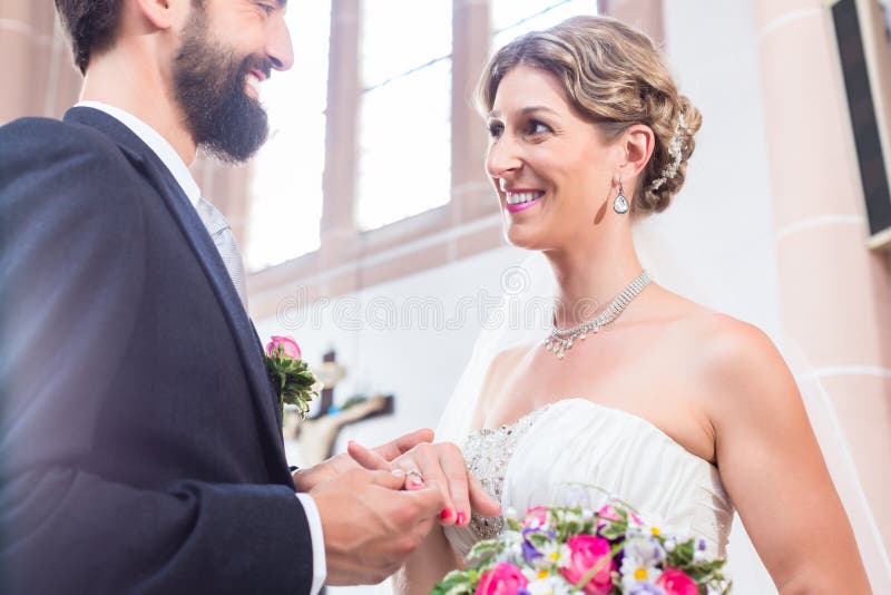 Groom Slipping Ring on Finger of Bride at Wedding Stock Photo - Image ...