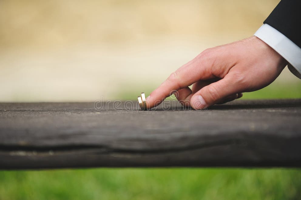 Groom Touching Rings stock photo. Image of bride, hand - 63201652