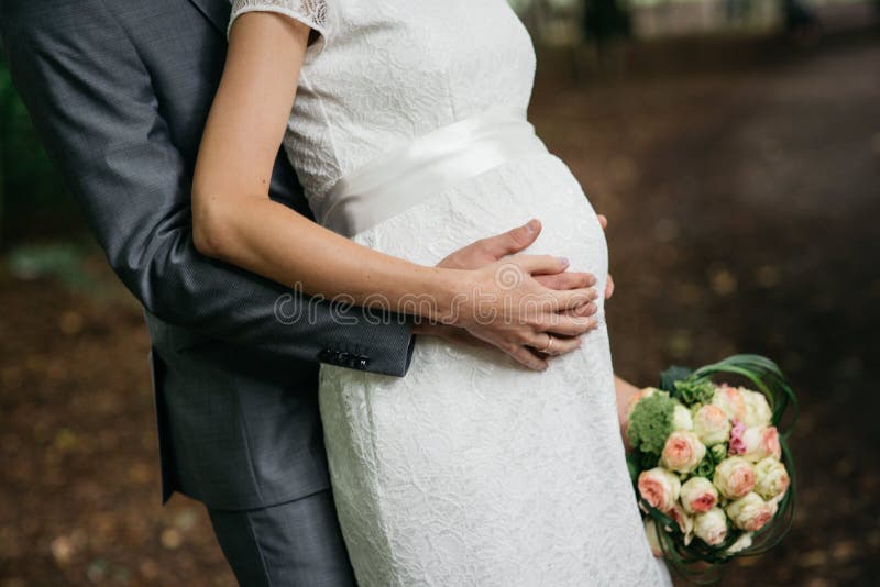 Groom at the Wedding Holds the Belly of the Pregnant Bride Stock Photo ...