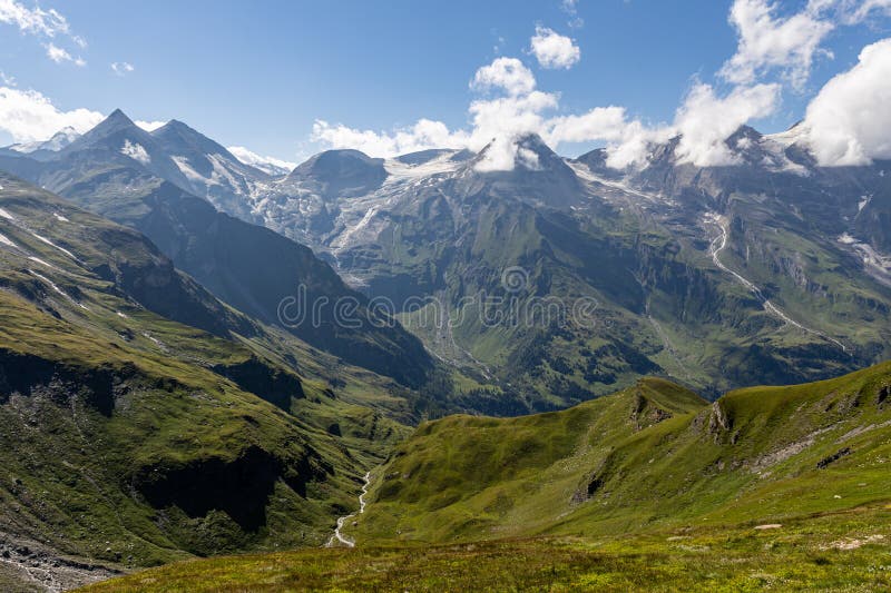 The Grossglockner Mountain Range with Snow on the Peaks and a Blue Sky ...