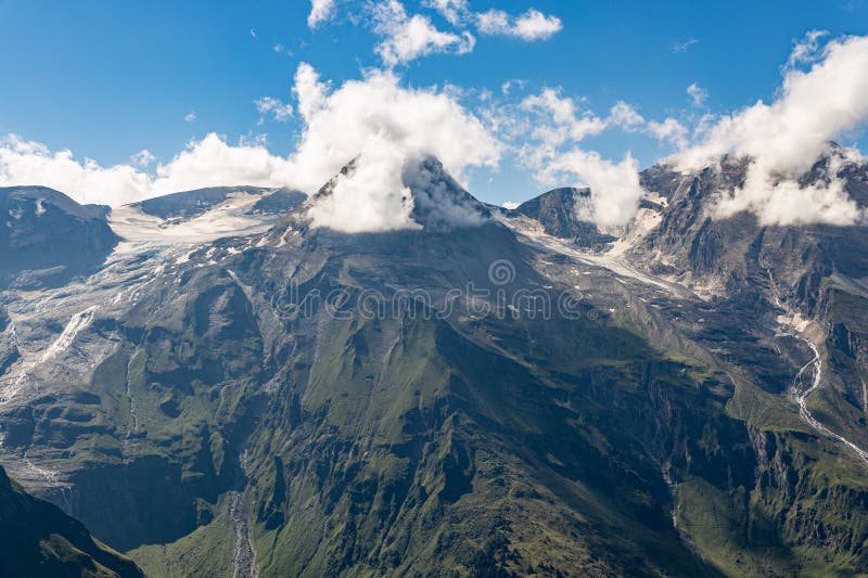 The Grossglockner Mountain Range with Snow on the Peaks and a Blue Sky ...