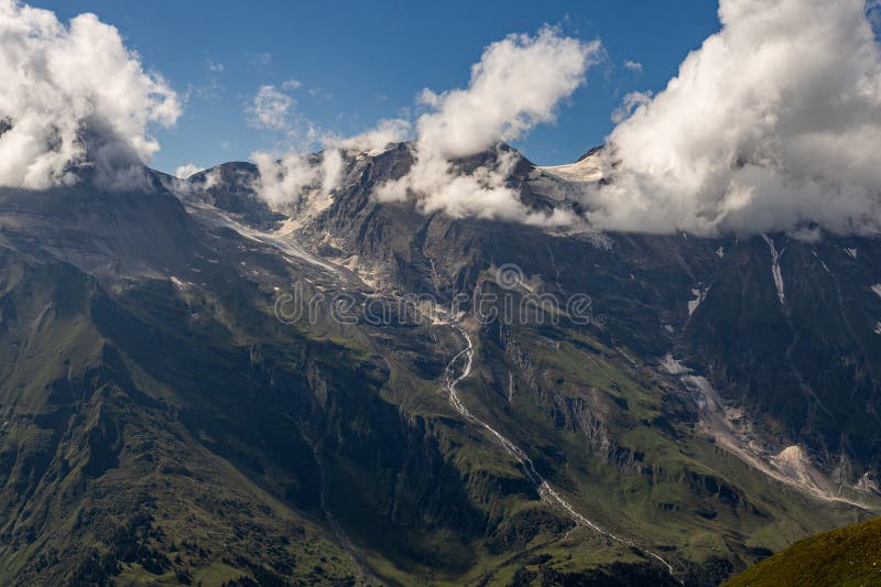 The Grossglockner Mountain Range with Snow on the Peaks and a Blue Sky ...