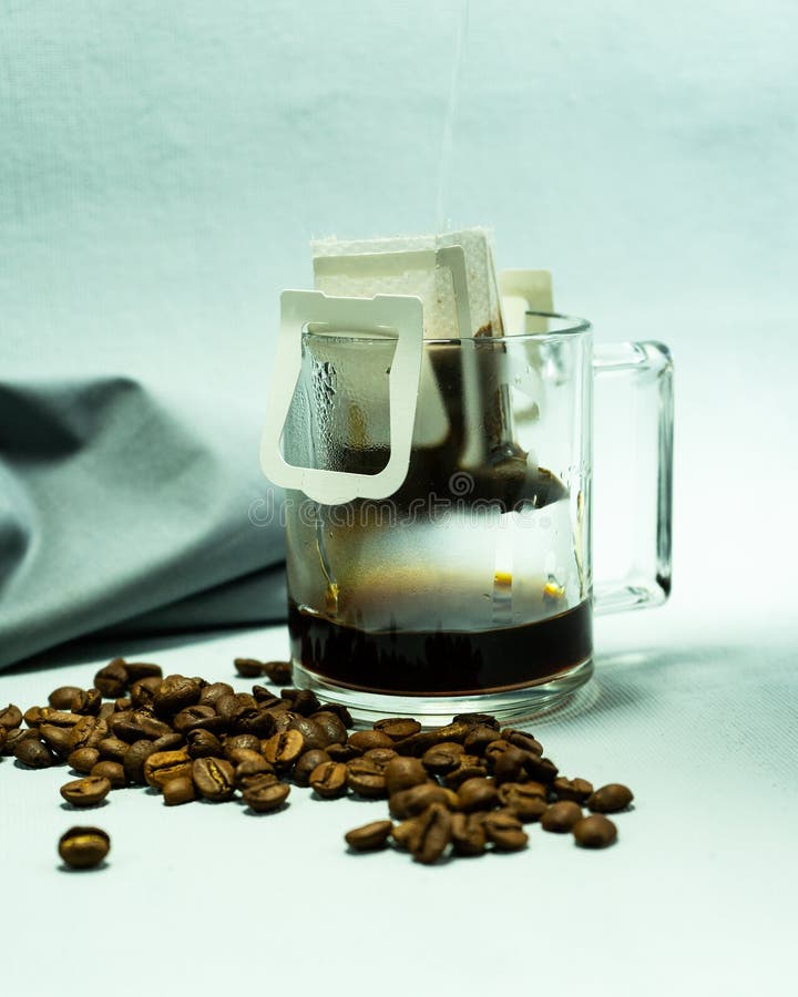 Ground, a Bag for Coffee Drops and a Transparent Mug on the Table. Drop ...