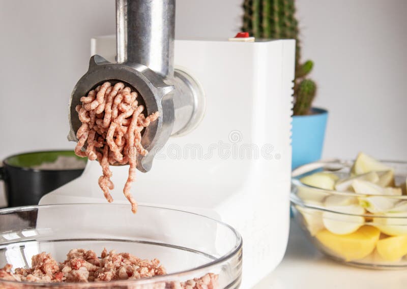 Ground Beef is Ground in a Meat Grinder, the Ingredients are in a Bowl ...