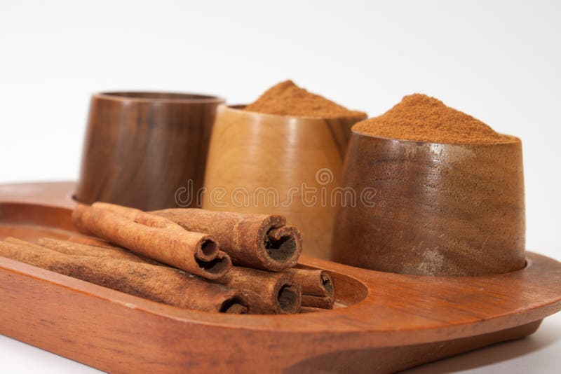 Ground Cinnamon and Cinnamon Sticks on Wooden Utensils Stock Photo ...
