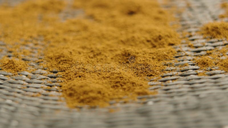 Ground Cinnamon Powder Falling on a Wicker Surface in Slow Motion Close ...