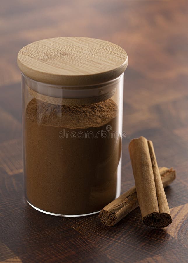 Ground Cinnamon and Cinnamon Sticks on a Wooden Butcher Block Stock ...