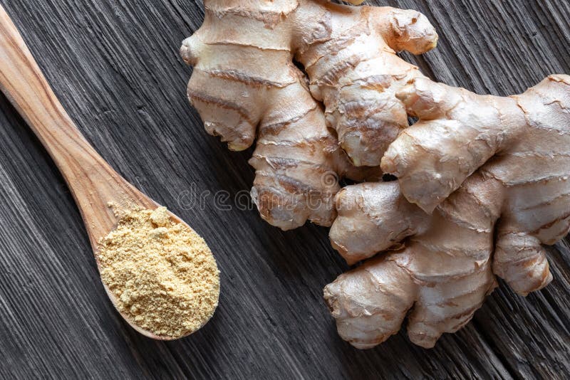 Ground Ginger on a Spoon with and Ginger Root on a Table Stock Image ...