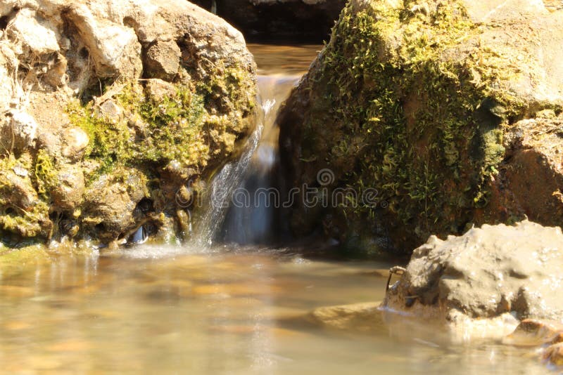 Ground Level Close Up of Mud and Water Sloshing Down a Stream Stock ...
