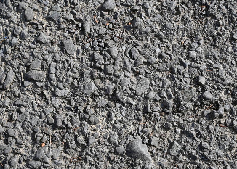 Ground Surface with Various Rock Textures and Pebbles Seen Under Bright ...