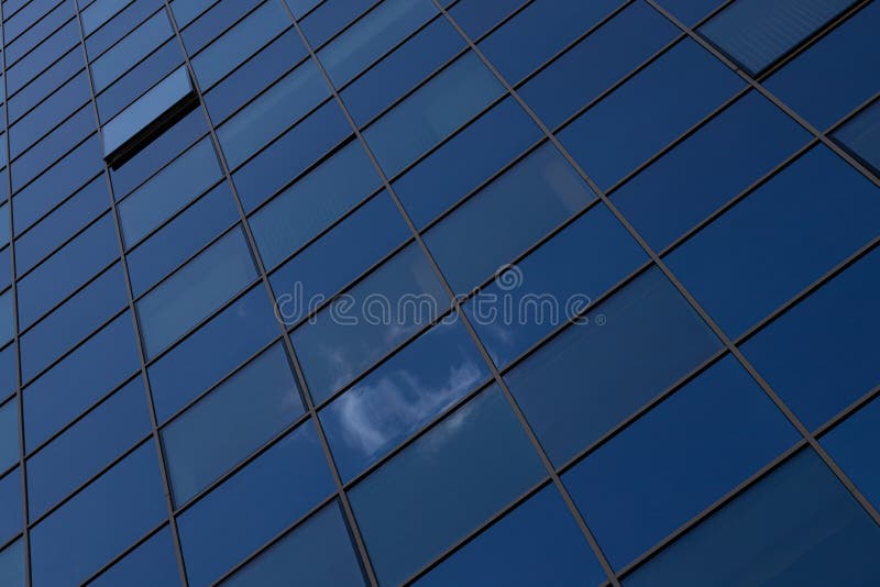 Ground View of Blue Glass Surface of Building Wall Reflecting Blue Sky ...
