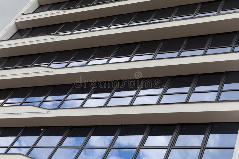 Ground View of Glass Square Windows on White Building Facade with Sky ...